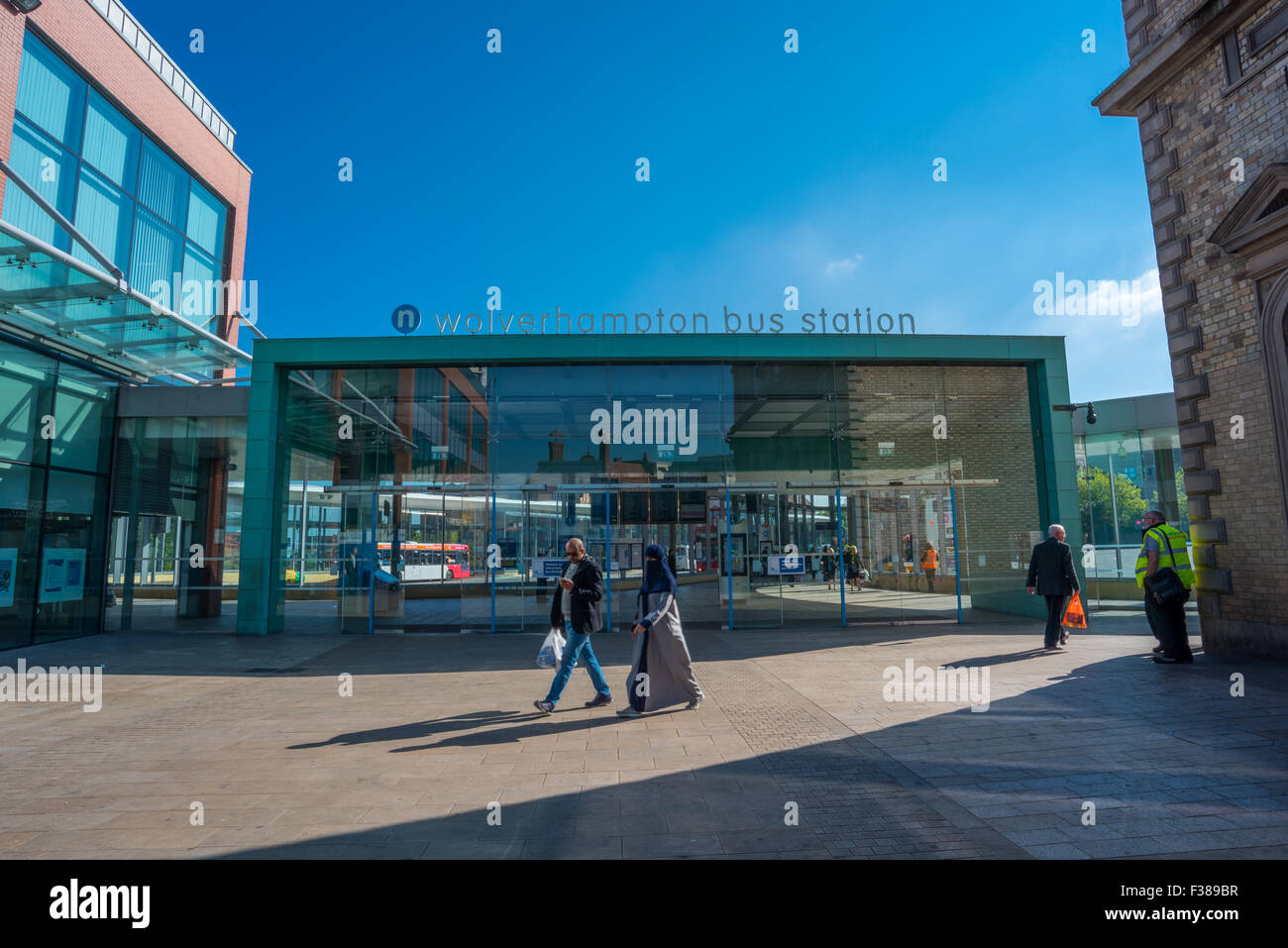 A Muslim couple walking past Wolverhampton Bus Station West midlands UK ...