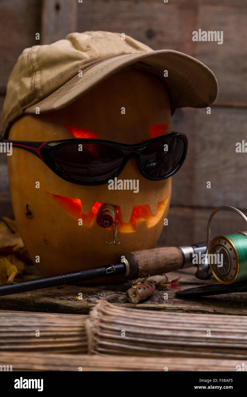halloween pumpkin head in heat and eyeglass with fishing tackles on ...