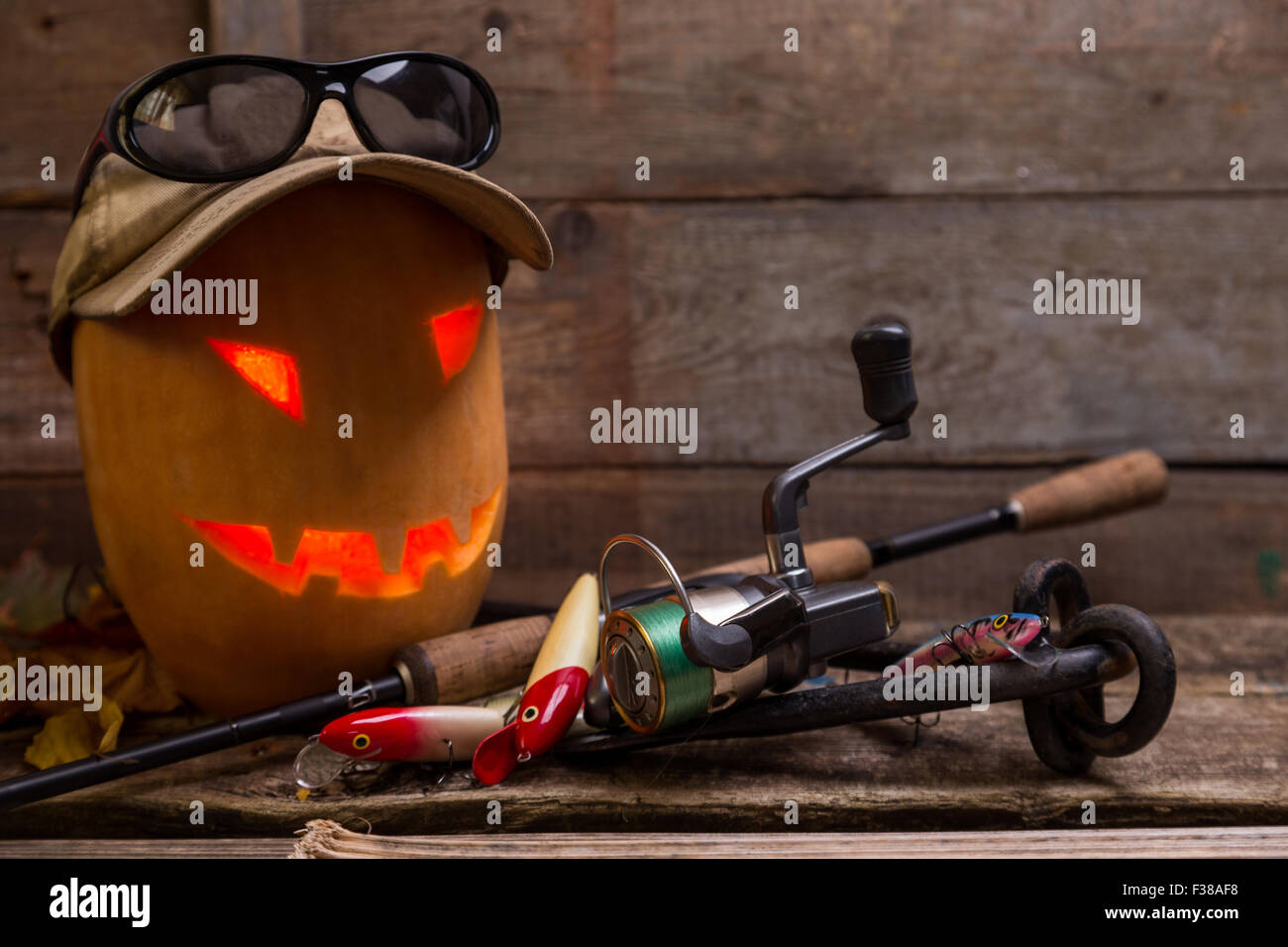 halloween pumpkin head in heat and eyeglass with fishing tackles on ...