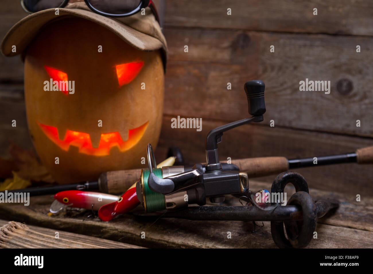 halloween pumpkin head in heat and eyeglass with fishing tackles on ...