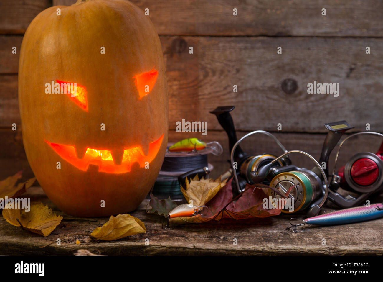 halloween pumpkin head in heat and eyeglass with fishing tackles on ...
