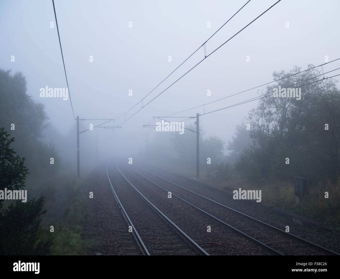 Train tracks leading into the mist Stock Photo - Alamy