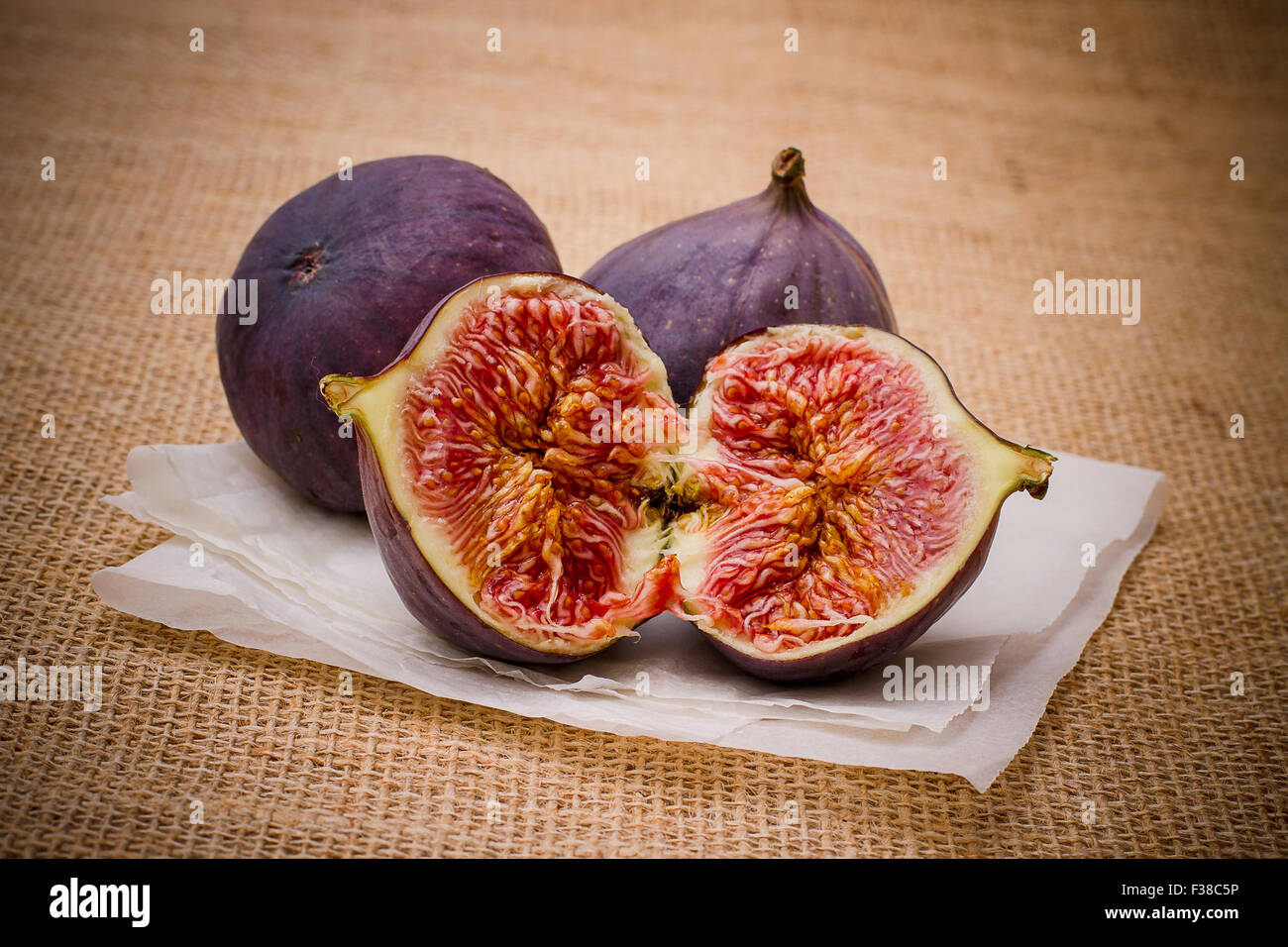Three ripe figs on baking paper background, close up Stock Photo - Alamy