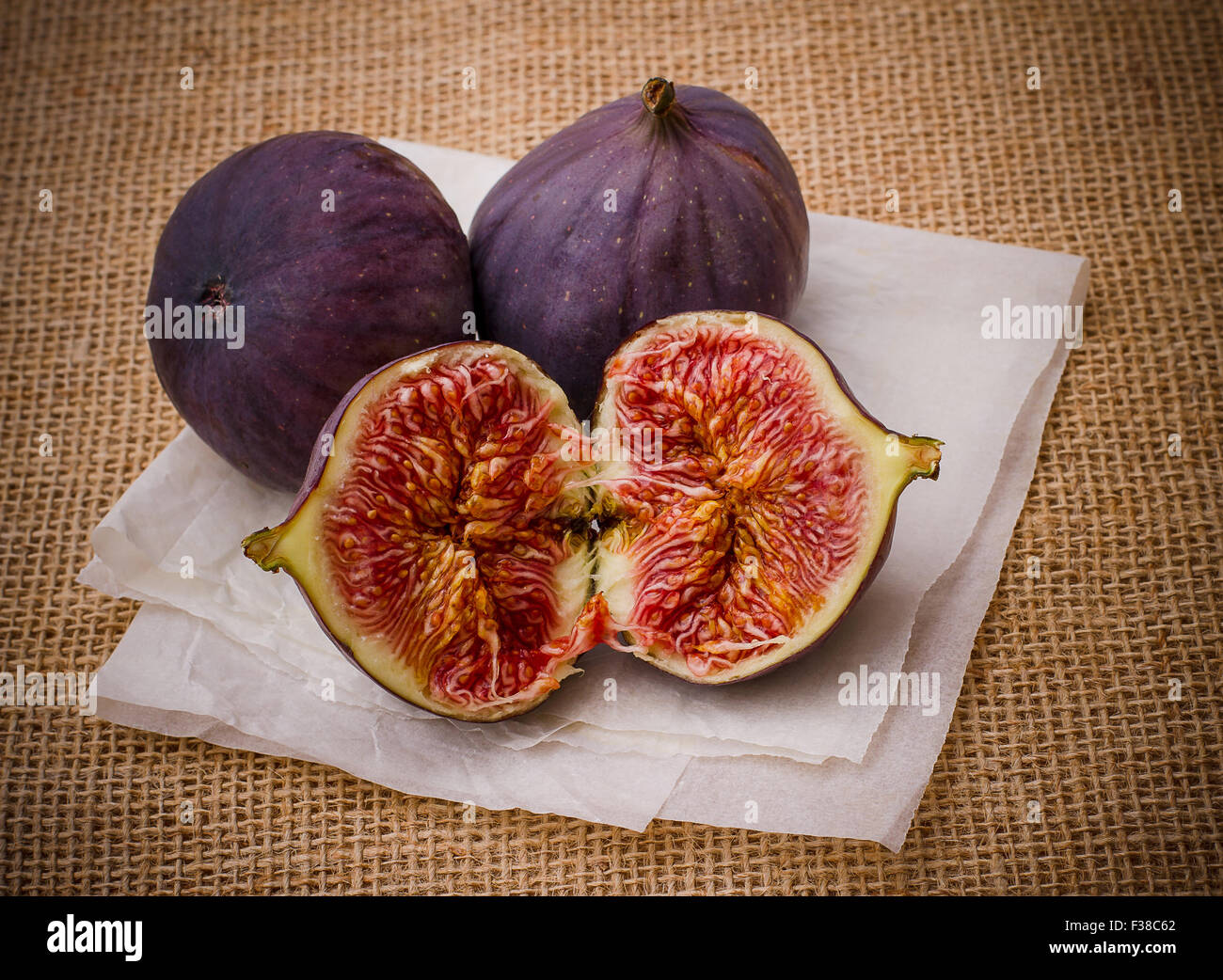 Three ripe figs on baking paper background, close up, top view Stock ...