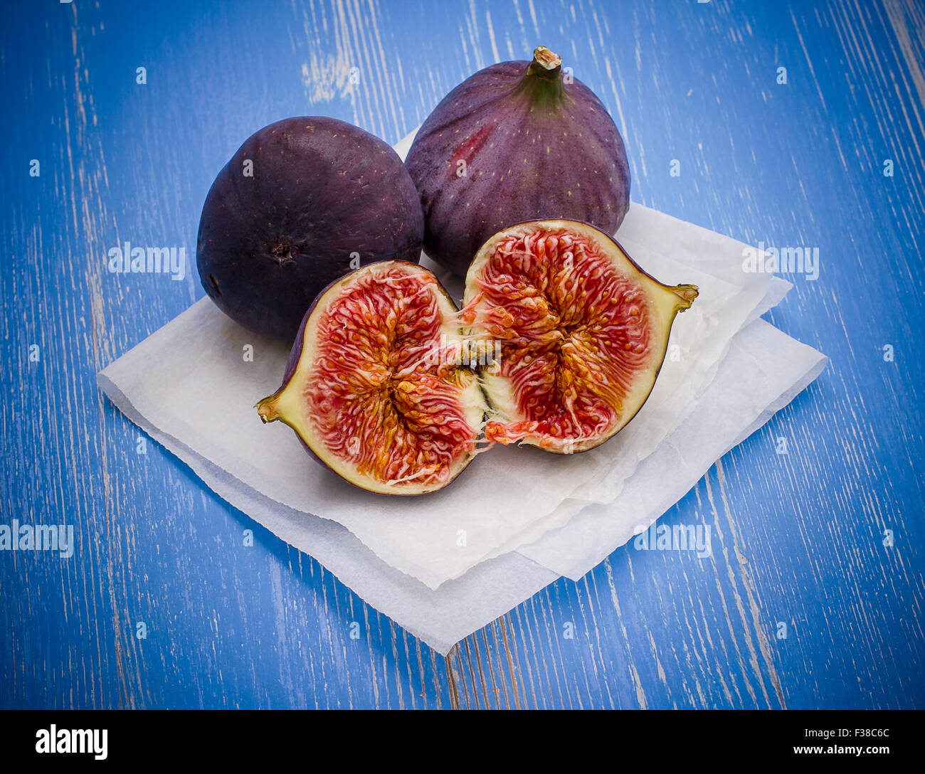 Three ripe figs on baking paper background, top view Stock Photo - Alamy