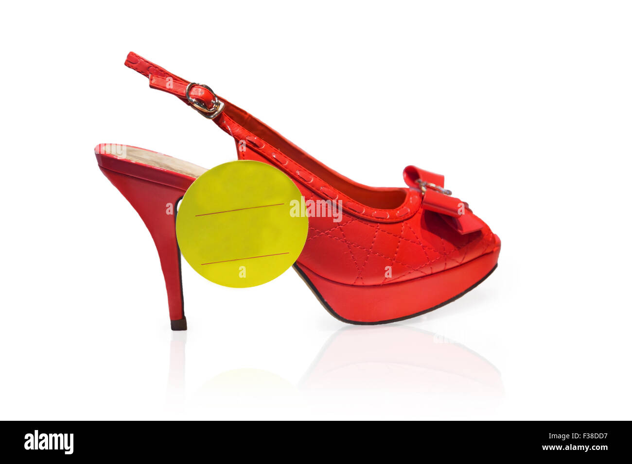 Women's red shoe with yellow label isolated on white background Stock ...