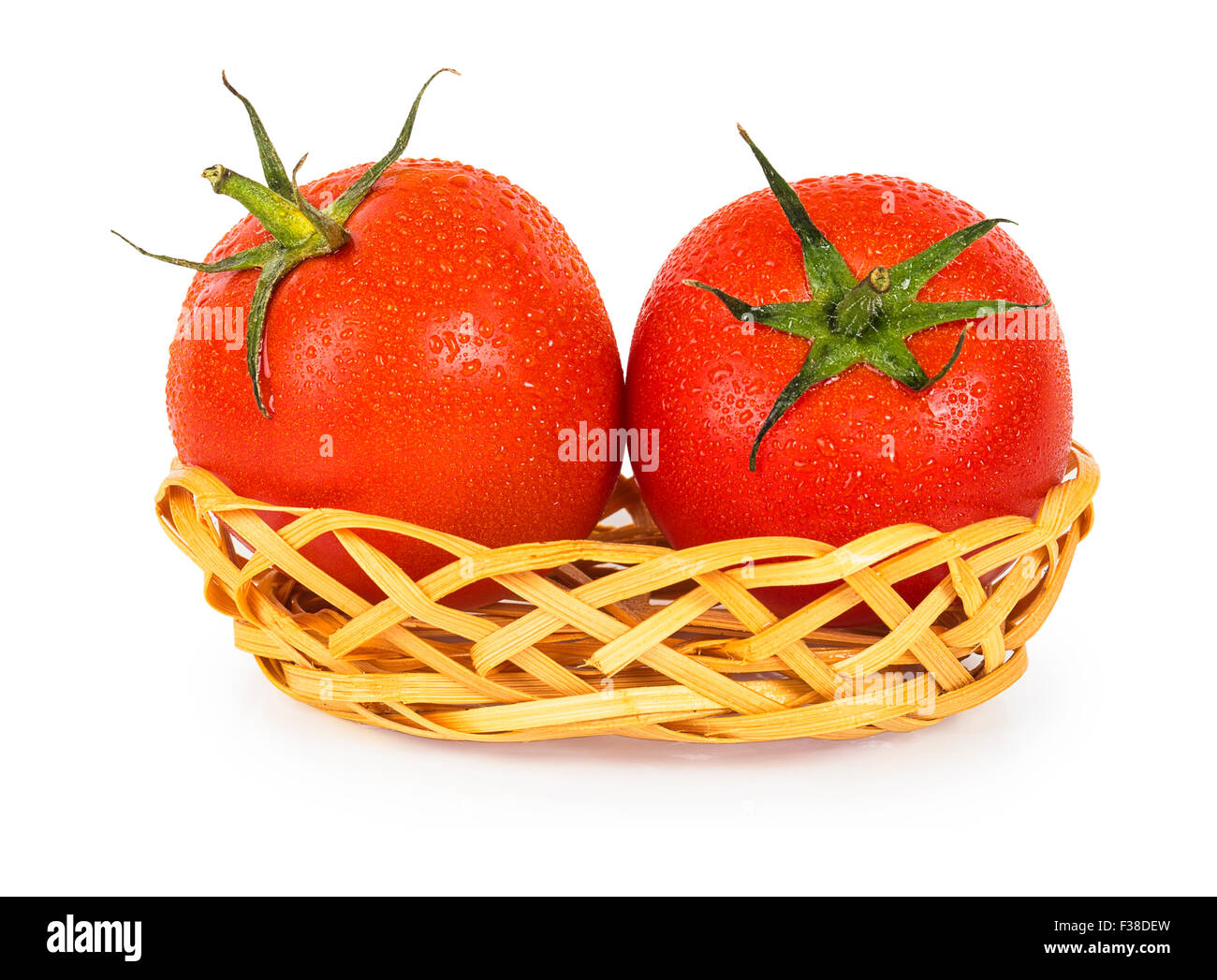 Two ripe juicy tomatoes in a basket isolated on white background Stock ...