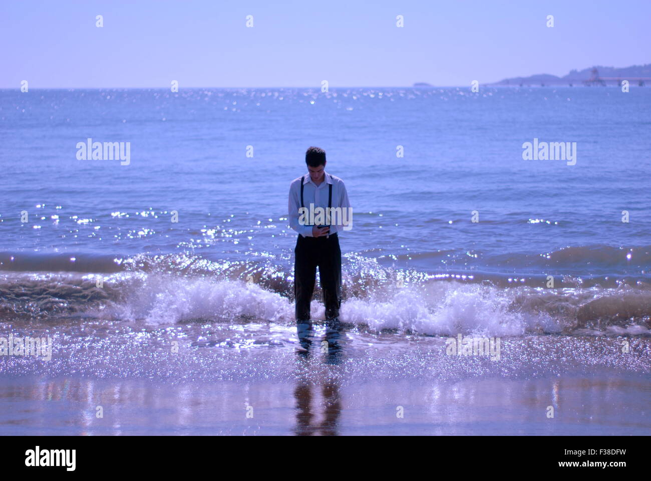 Man standing in ocean waves hi-res stock photography and images - Alamy
