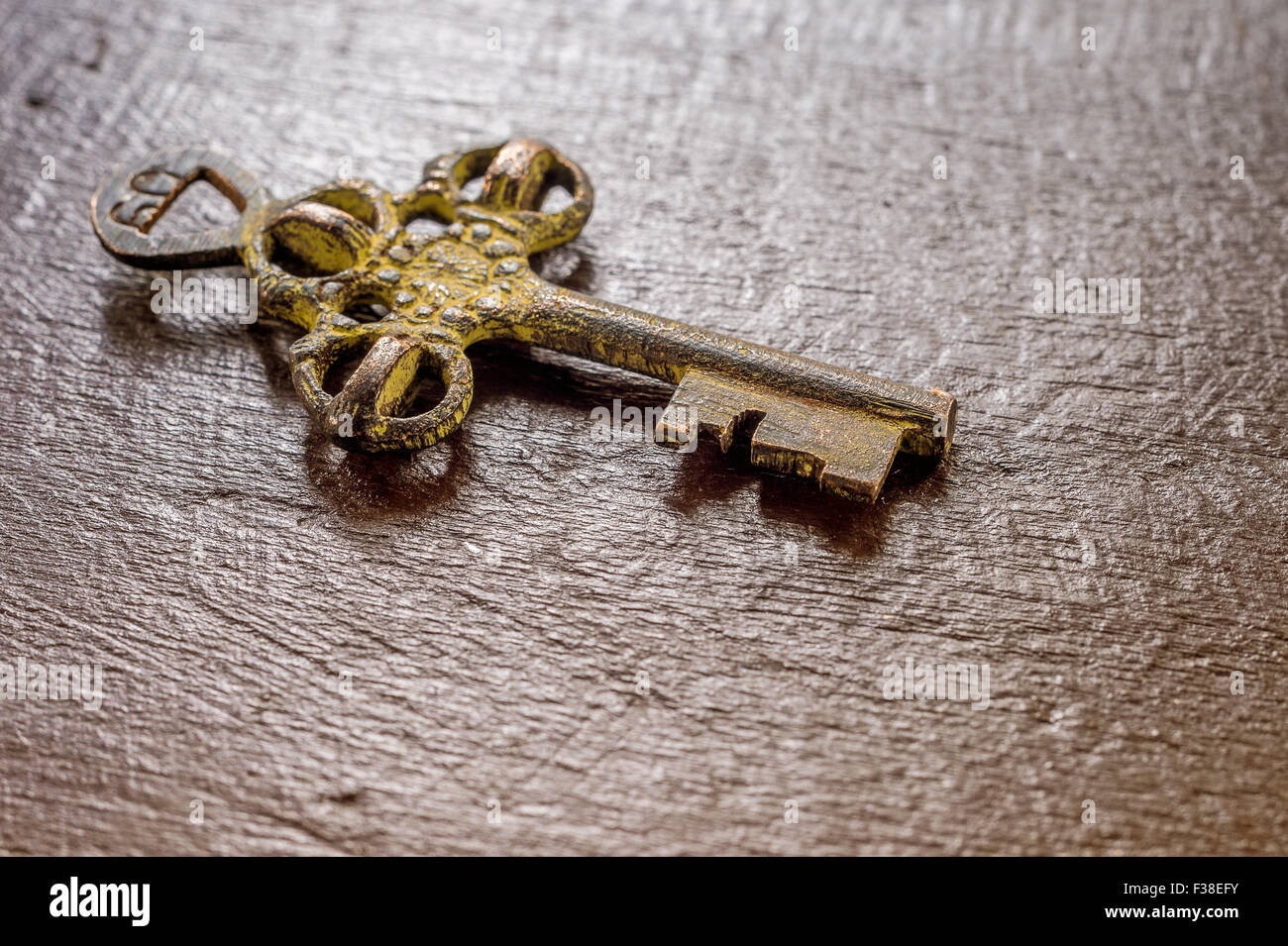 Old treasure key on wood surface Stock Photo - Alamy
