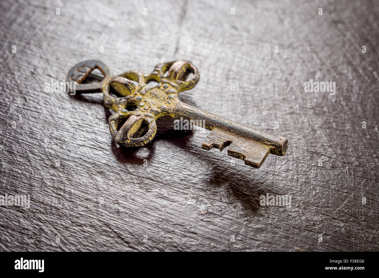 Old treasure key on wood surface Stock Photo - Alamy