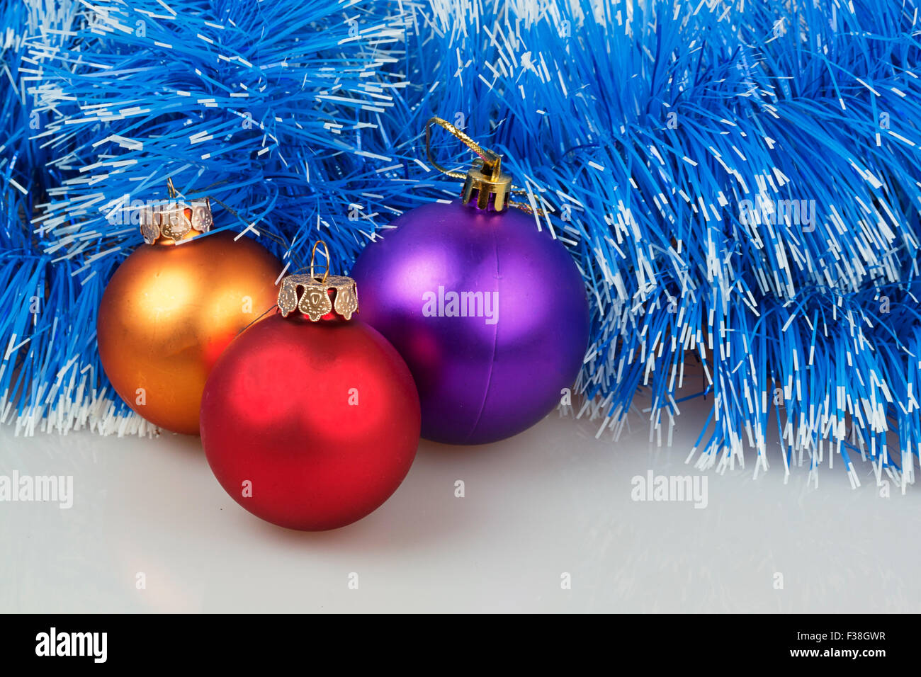 three Christmas balsl with blue garland Stock Photo - Alamy