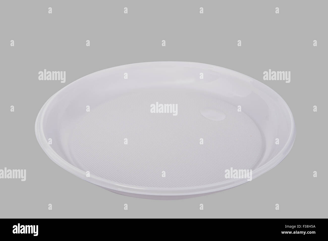 disposable plastic plate on a gray background Stock Photo - Alamy