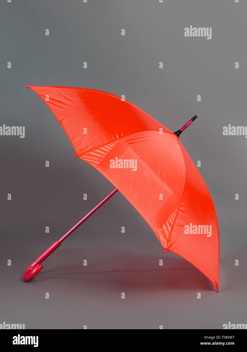 opened red umbrella isolated on gray background Stock Photo - Alamy