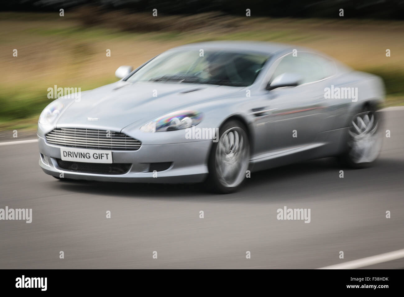 Aston Martin DBS sports car on race circuit, slow shutter speed ...