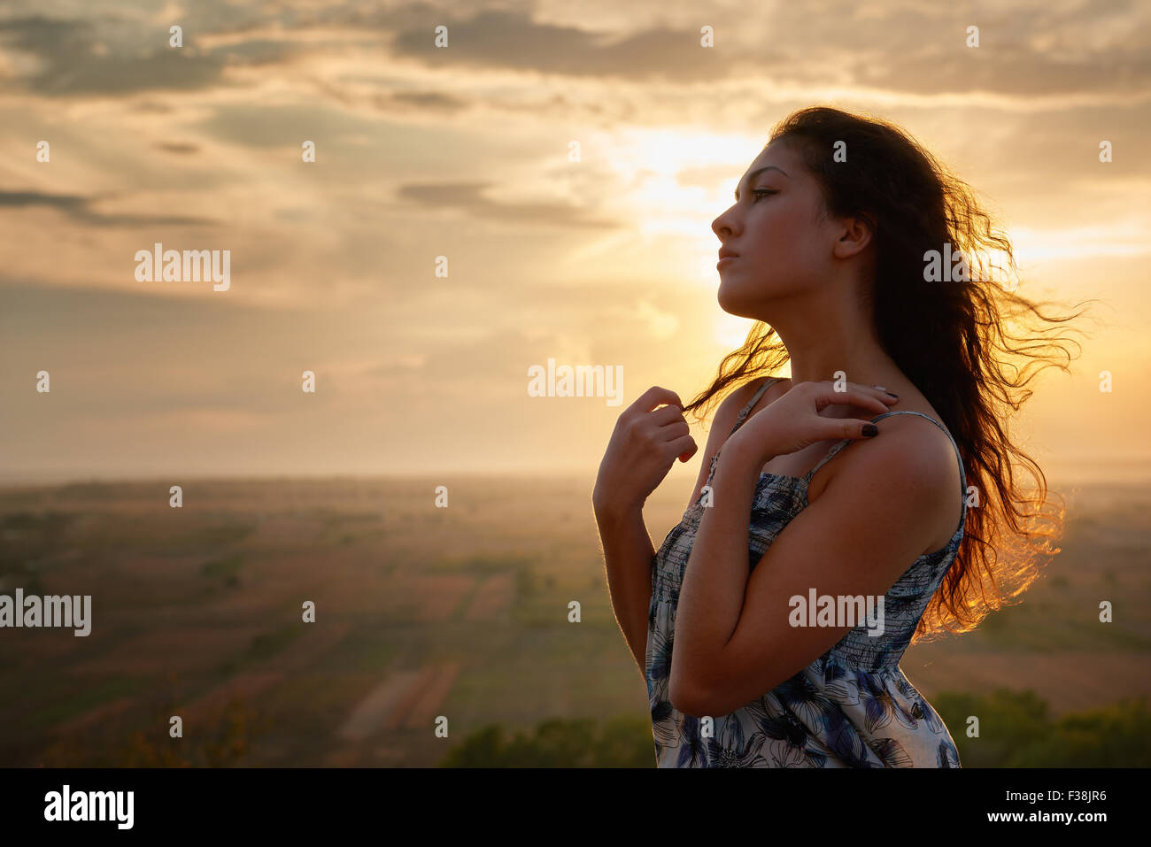 girl portrait at sunset on plain background Stock Photo - Alamy