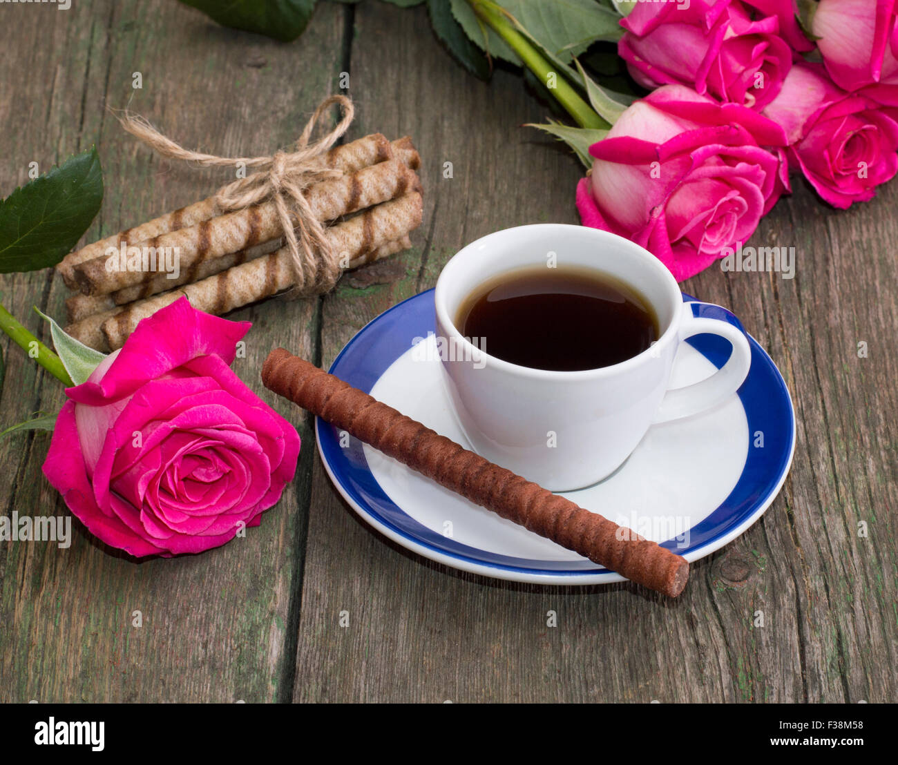 coffee still life, cookies in the form of sticks and a rose on each ...