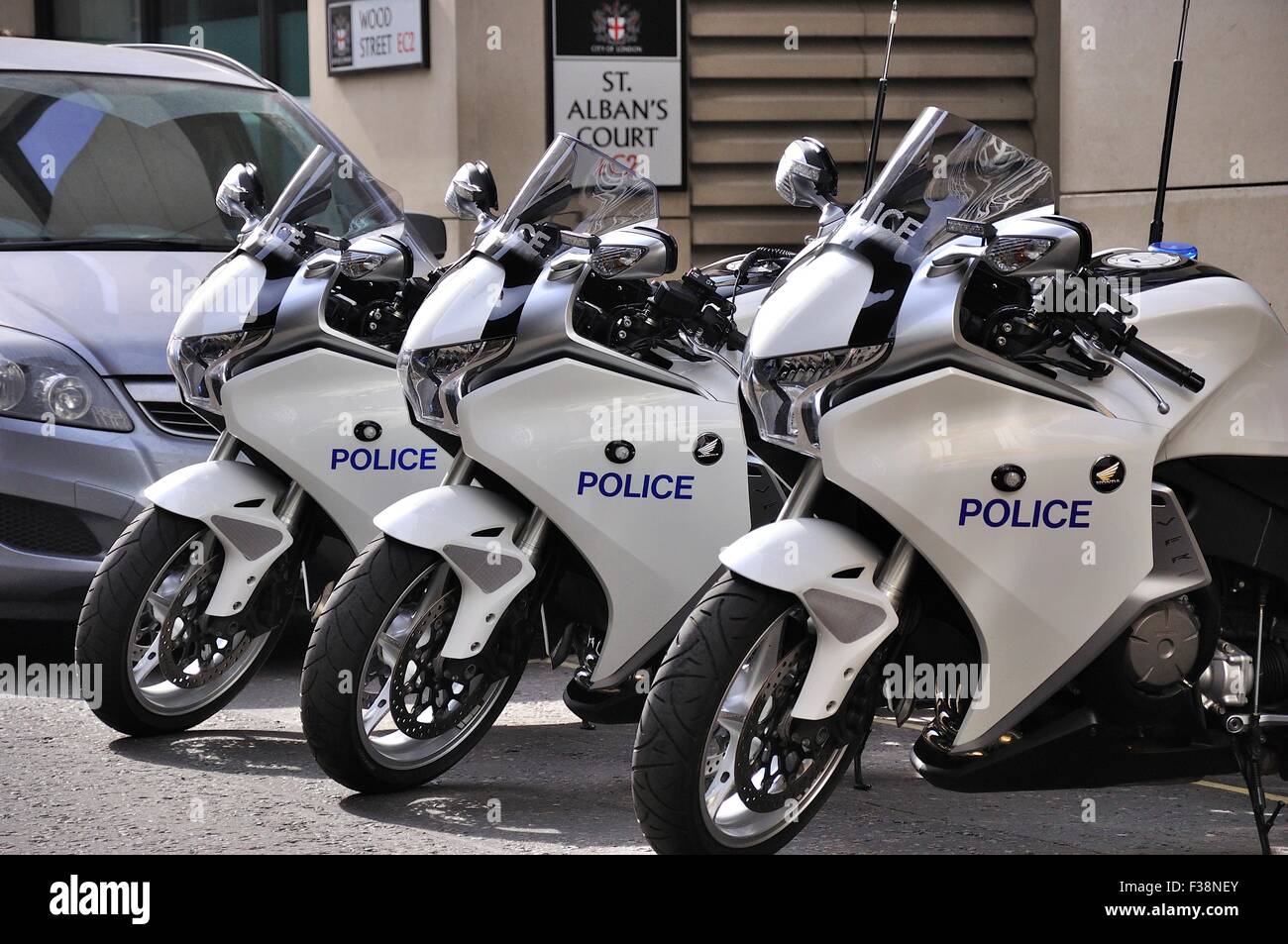 Group of three police motorcycles parked in Wood Street, City of London ...
