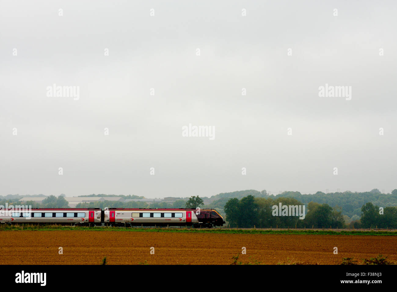 A train speeds by farm land Stock Photo - Alamy