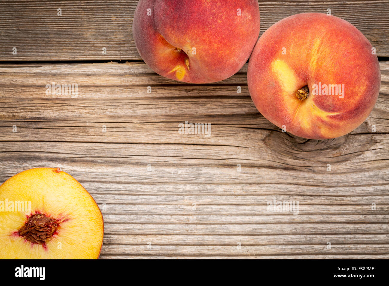 fresh peach fruits on weathered grained cedar wood with a copy space ...