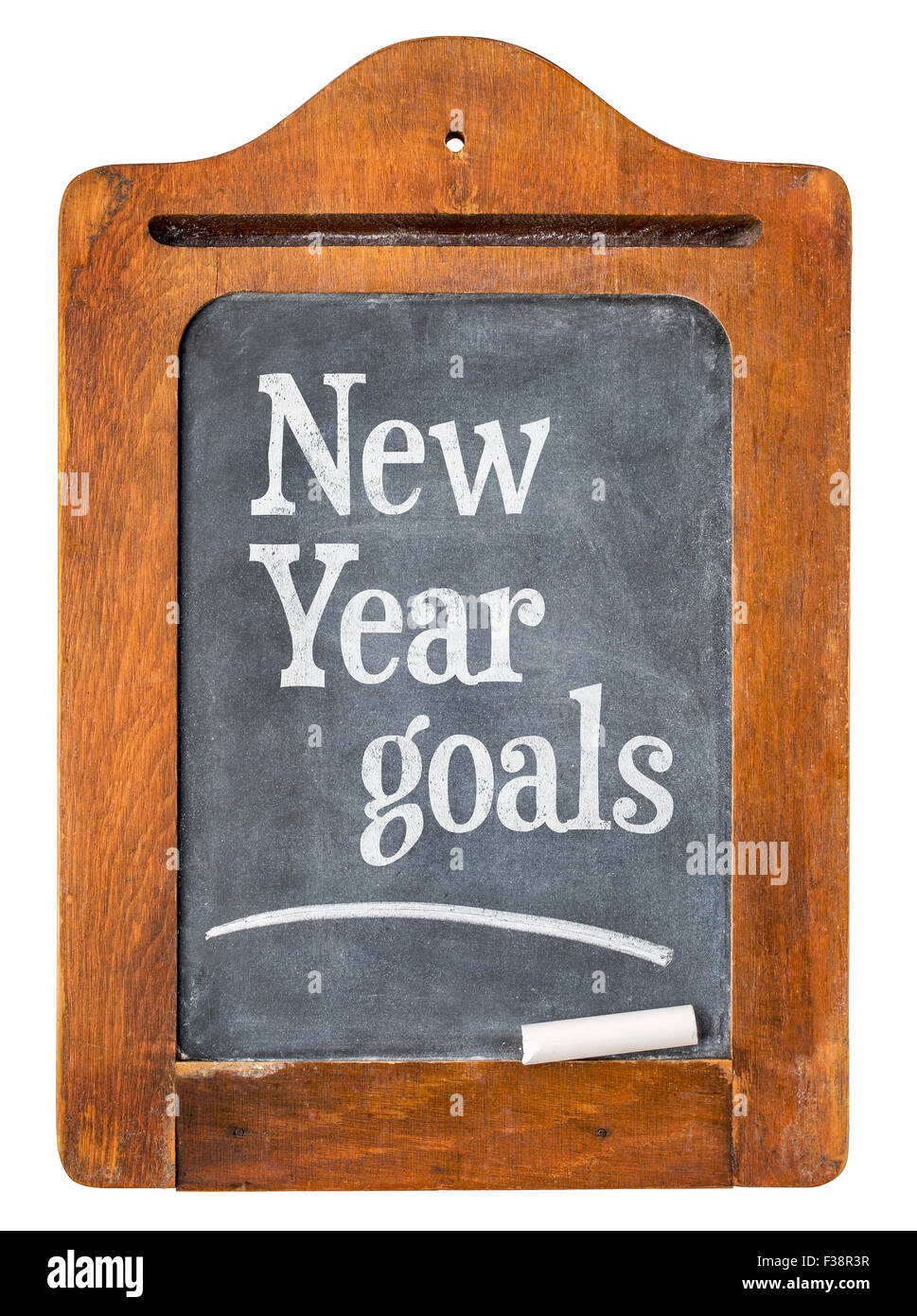 New Year goals on a small vintage slate blackboard in rustic wooden ...