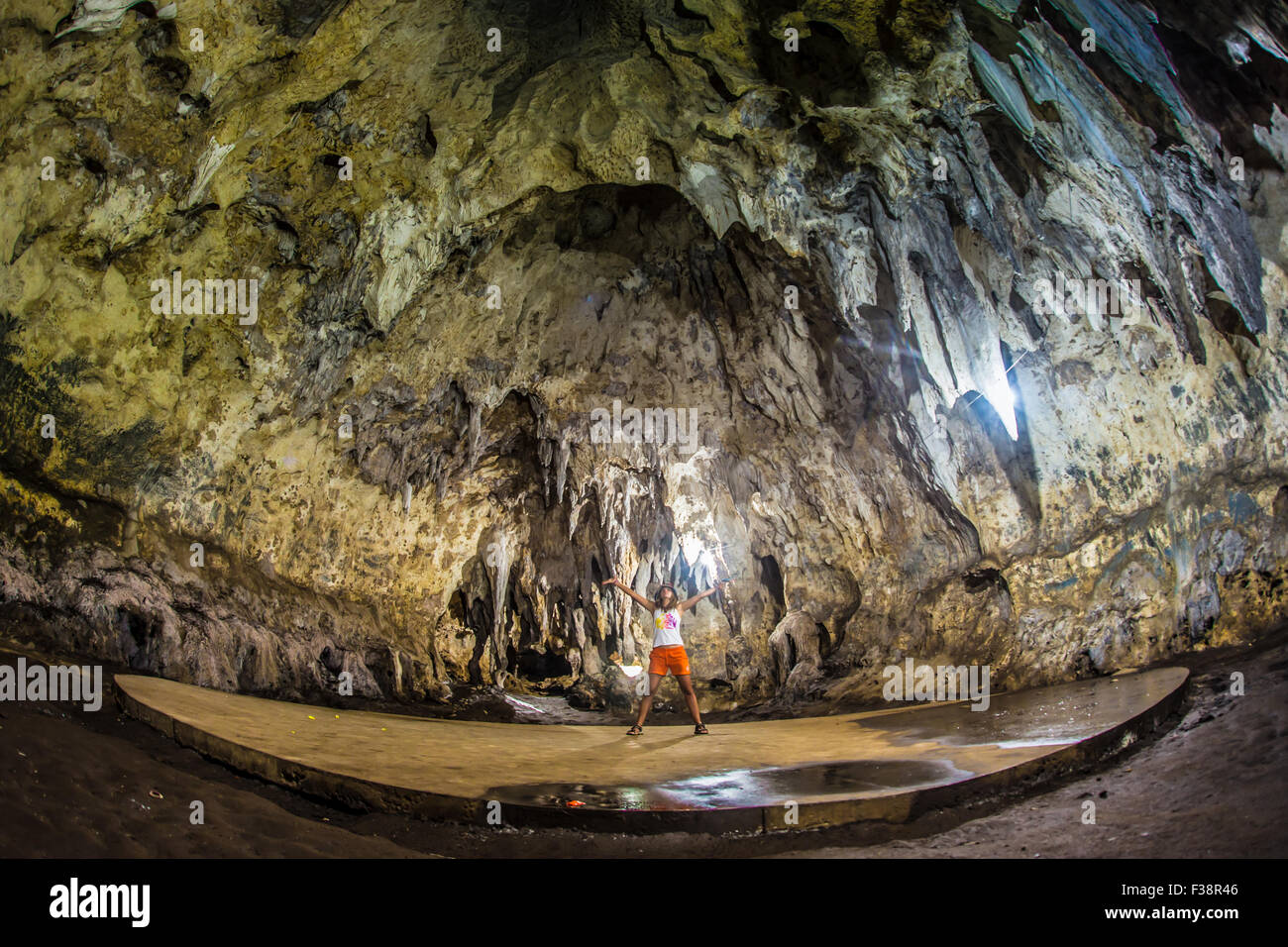 Young woman with backpack exploring cave Stock Photo - Alamy