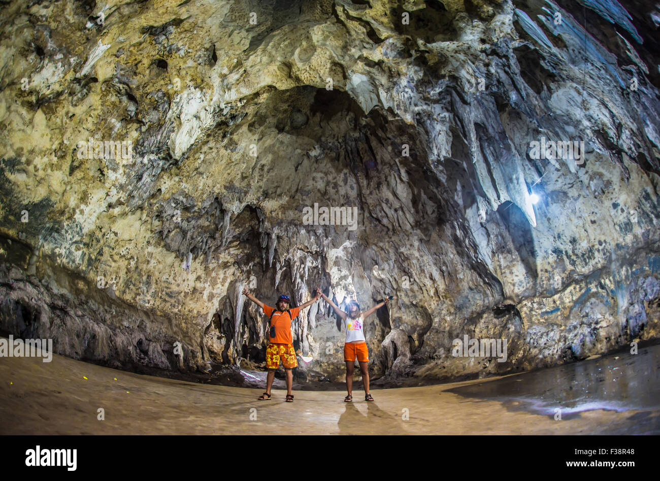 Young woman with backpack exploring cave Stock Photo - Alamy