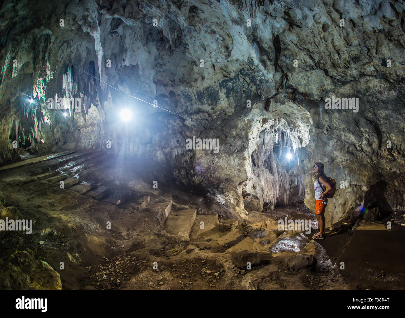 Young woman with backpack exploring cave Stock Photo - Alamy