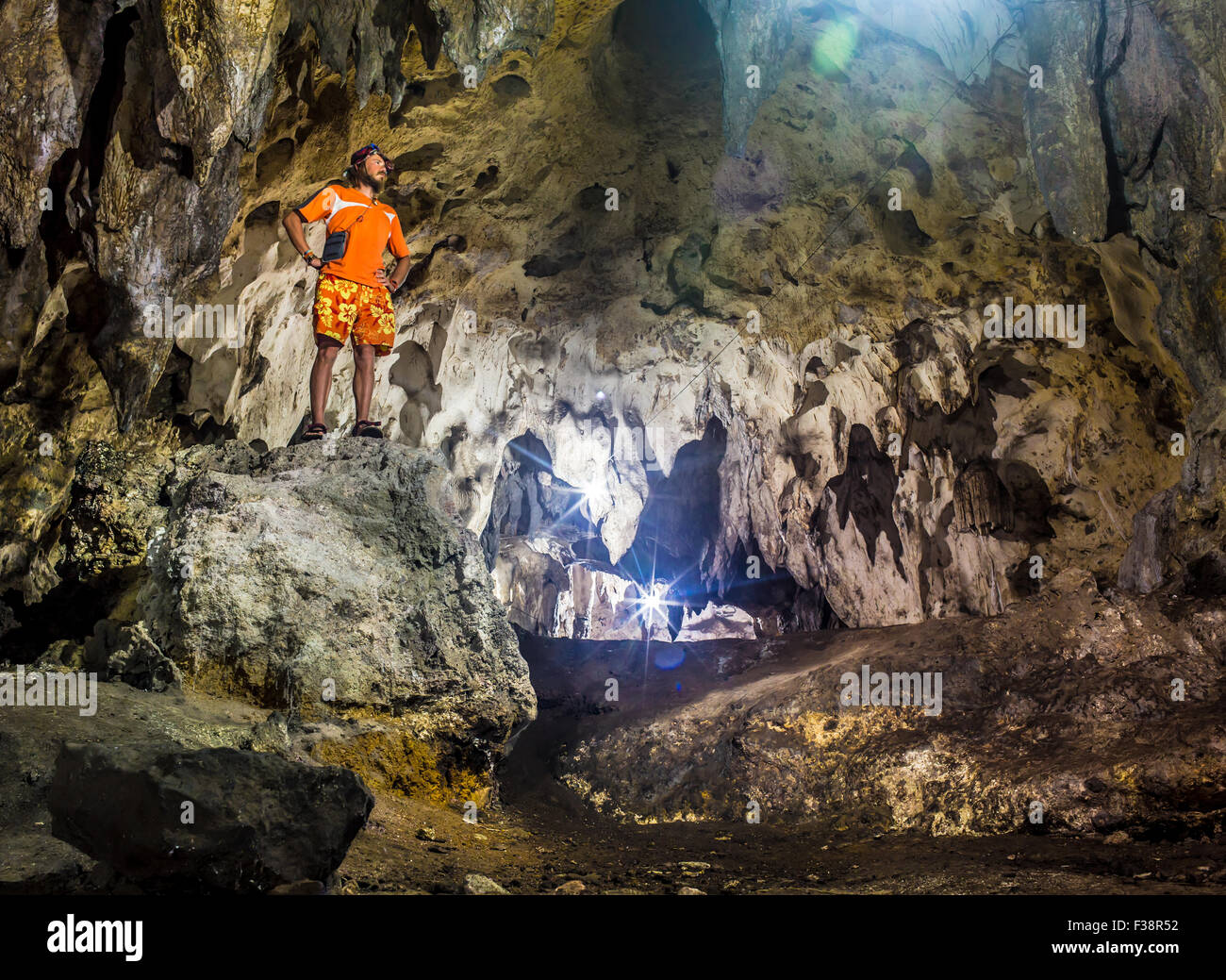 Young woman with backpack exploring cave Stock Photo - Alamy