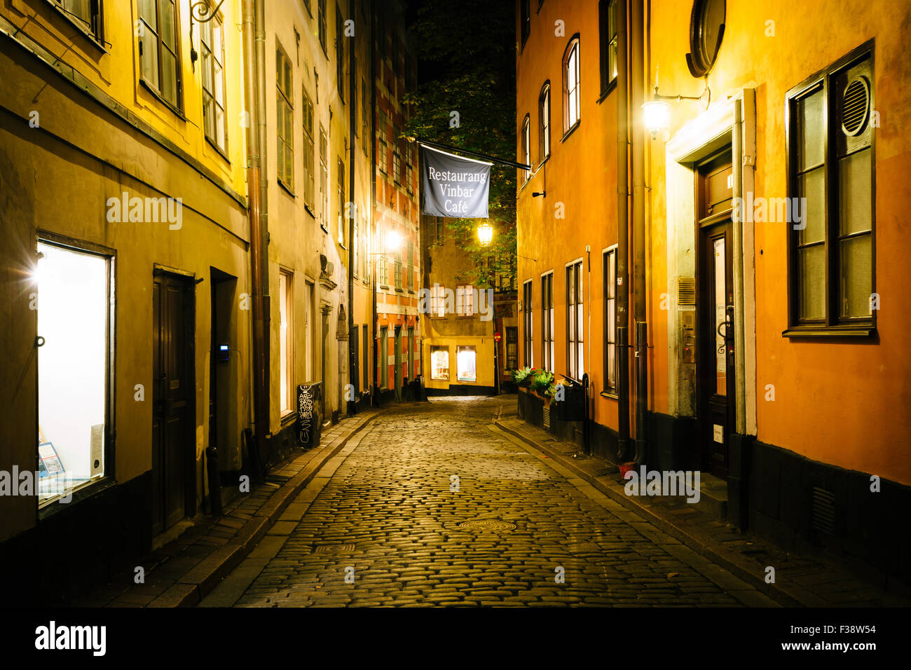A narrow cobblestone street at night, in Galma Stan, Stockholm, Sweden ...