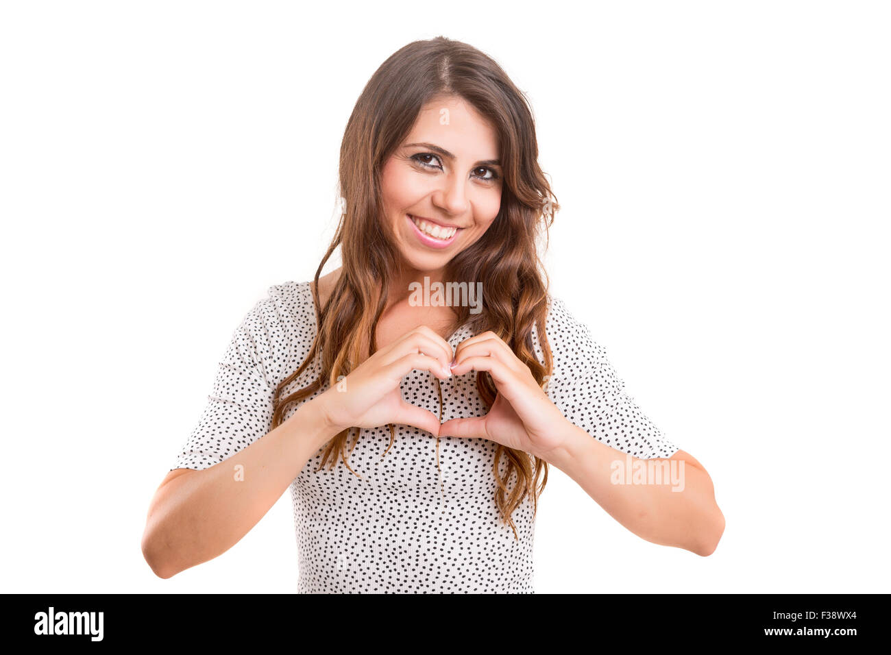 Beautiful woman making a heart shape with her hands, isolated over ...