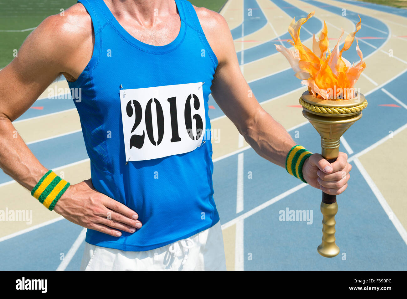 Athlete wearing 2016 race bib holding sport torch in front of running ...