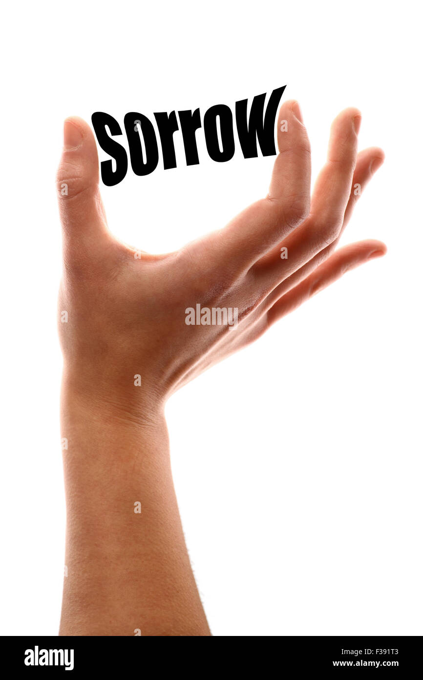 Color vertical shot of a hand squeezing the word "sorrow Stock Photo ...