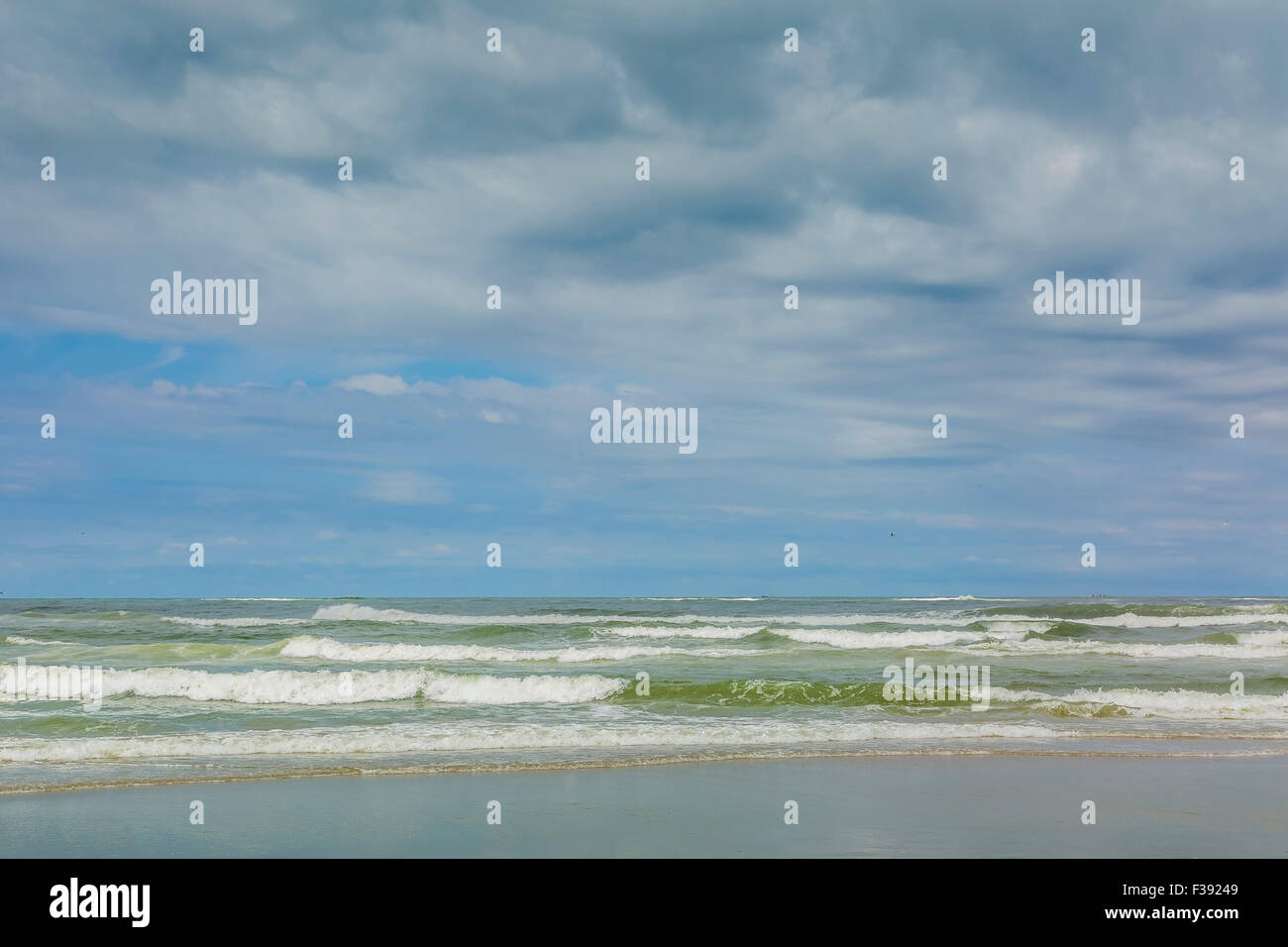 Beach and roiling ocean in cloudy atmosphere, Texel, West Frisian ...