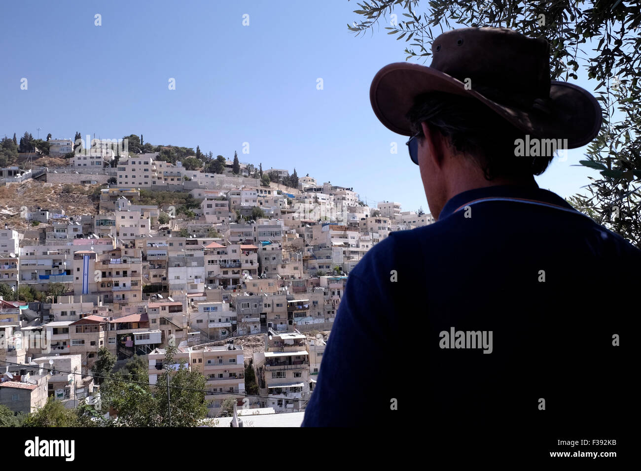 An Israeli man looking the Palestinian neighbourhood of Silwan or ...