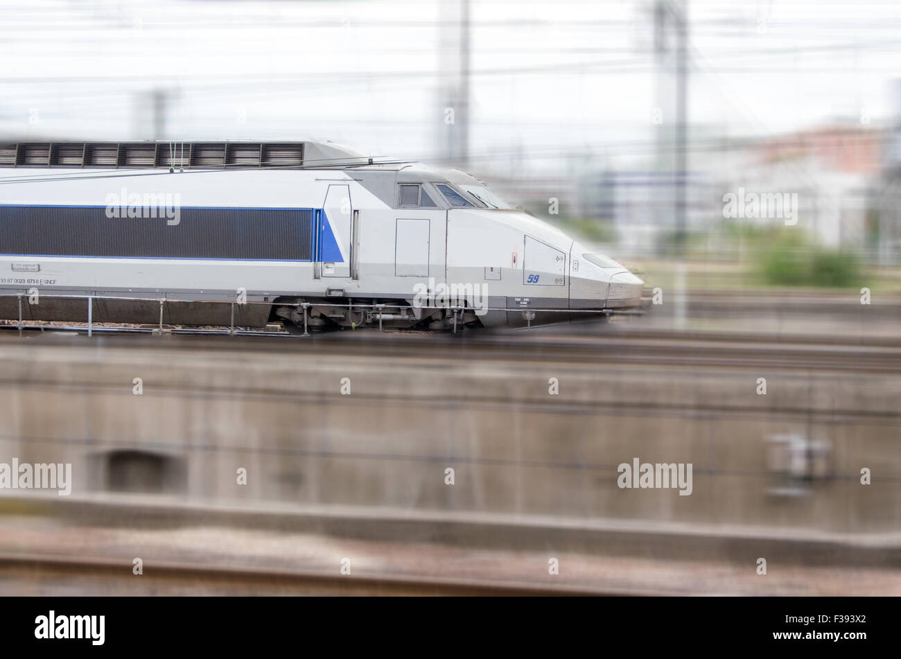 Blue and grey high-speed train on a blurry and urban background Stock ...