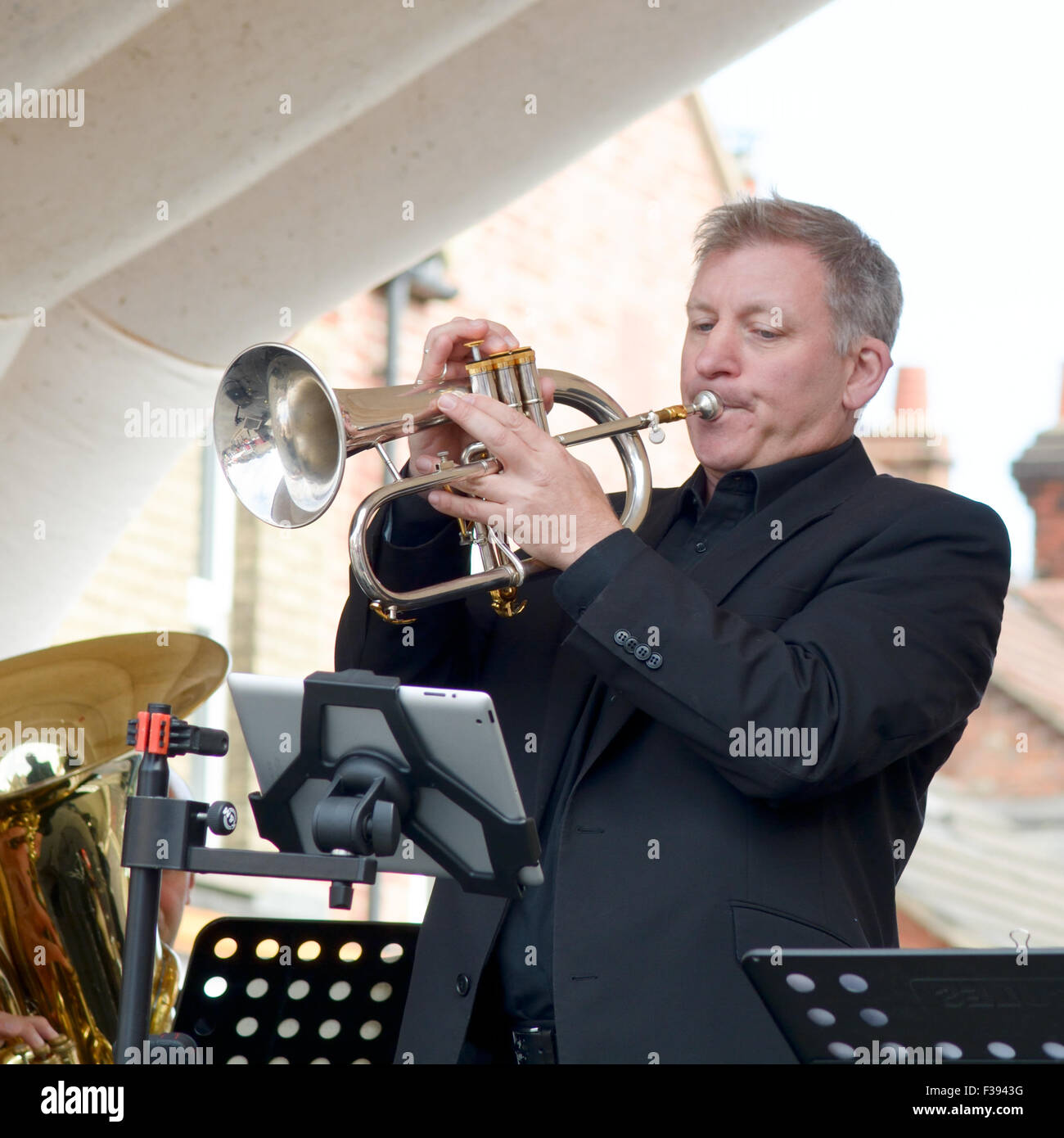 Musician playing a trumpet on stage at the Castle Road Festival (free ...