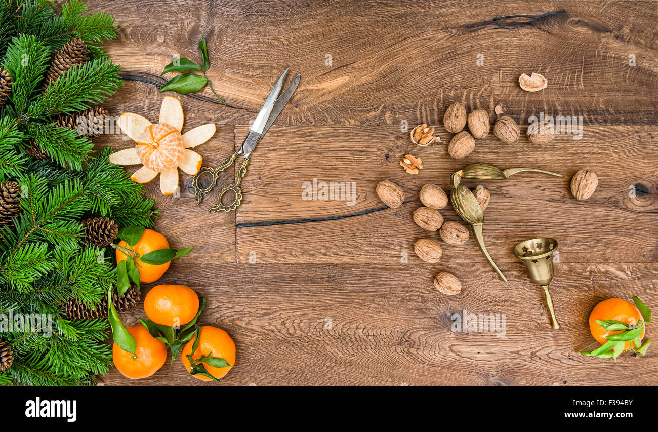Orange mandarin fruits, walnuts and vintage accessories. Christmas tree ...