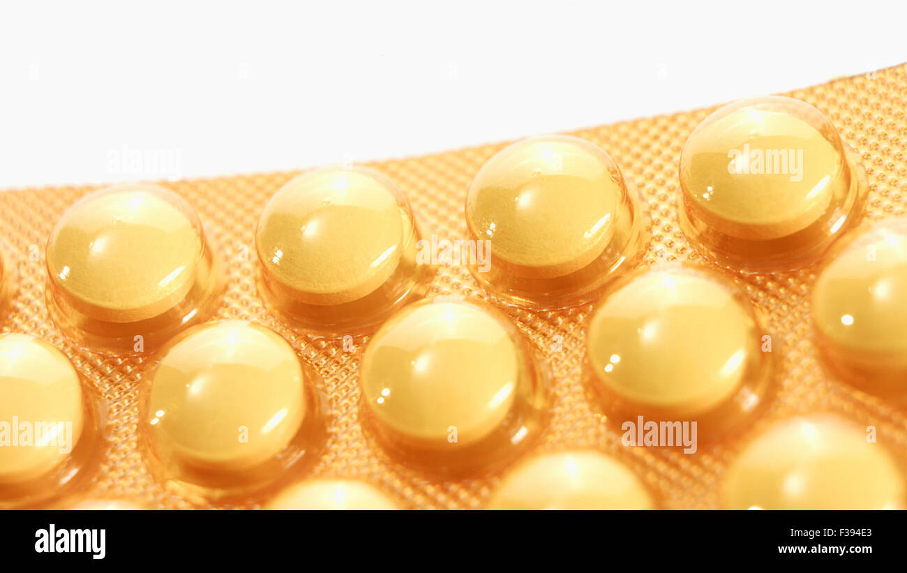 Yellow pills medications Stock Photo - Alamy