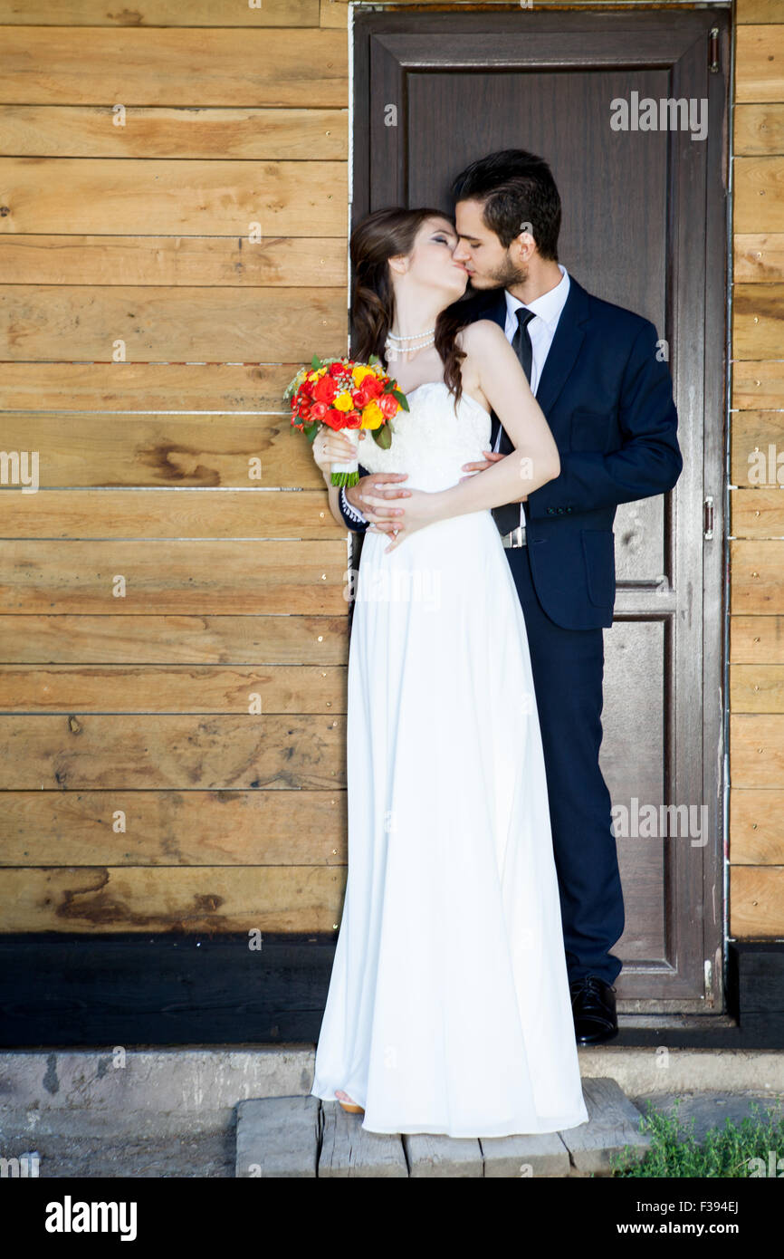 Young just married couple in front of the door. Happy familly. Wedding ...