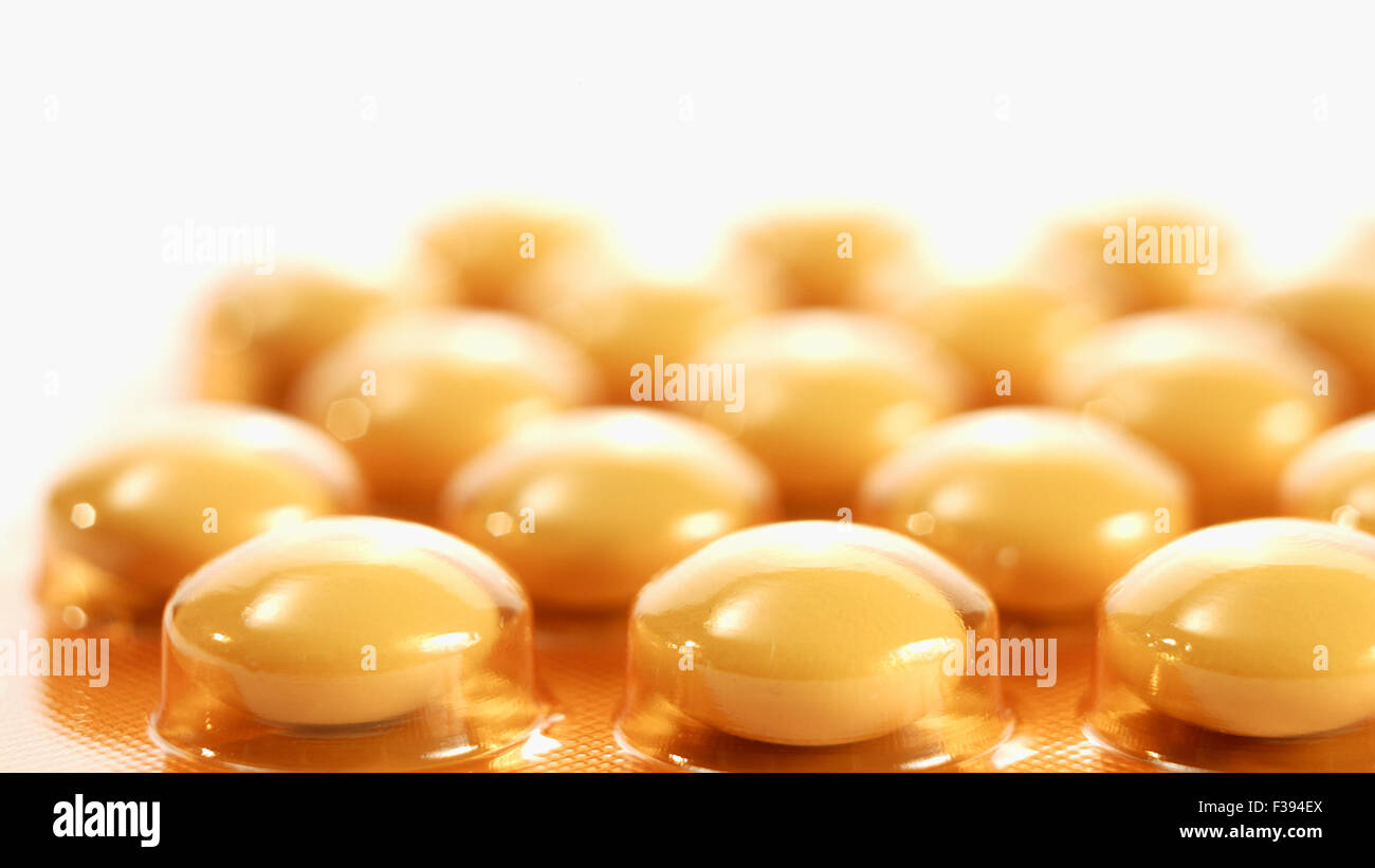 Yellow medical pills Stock Photo - Alamy
