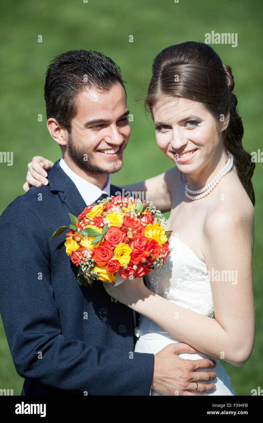 Happy just married bride and groom on green grass background. Just ...