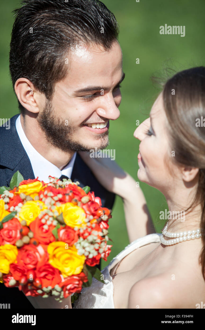 Happy just married bride and groom on green grass background. Just ...