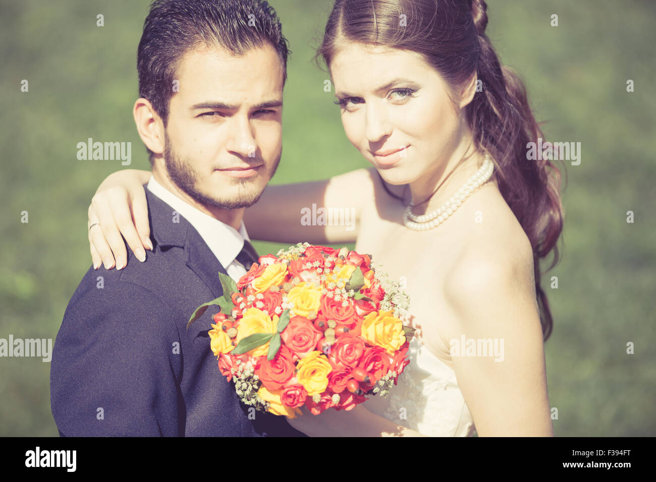 Happy just married bride and groom on green grass background. Just ...
