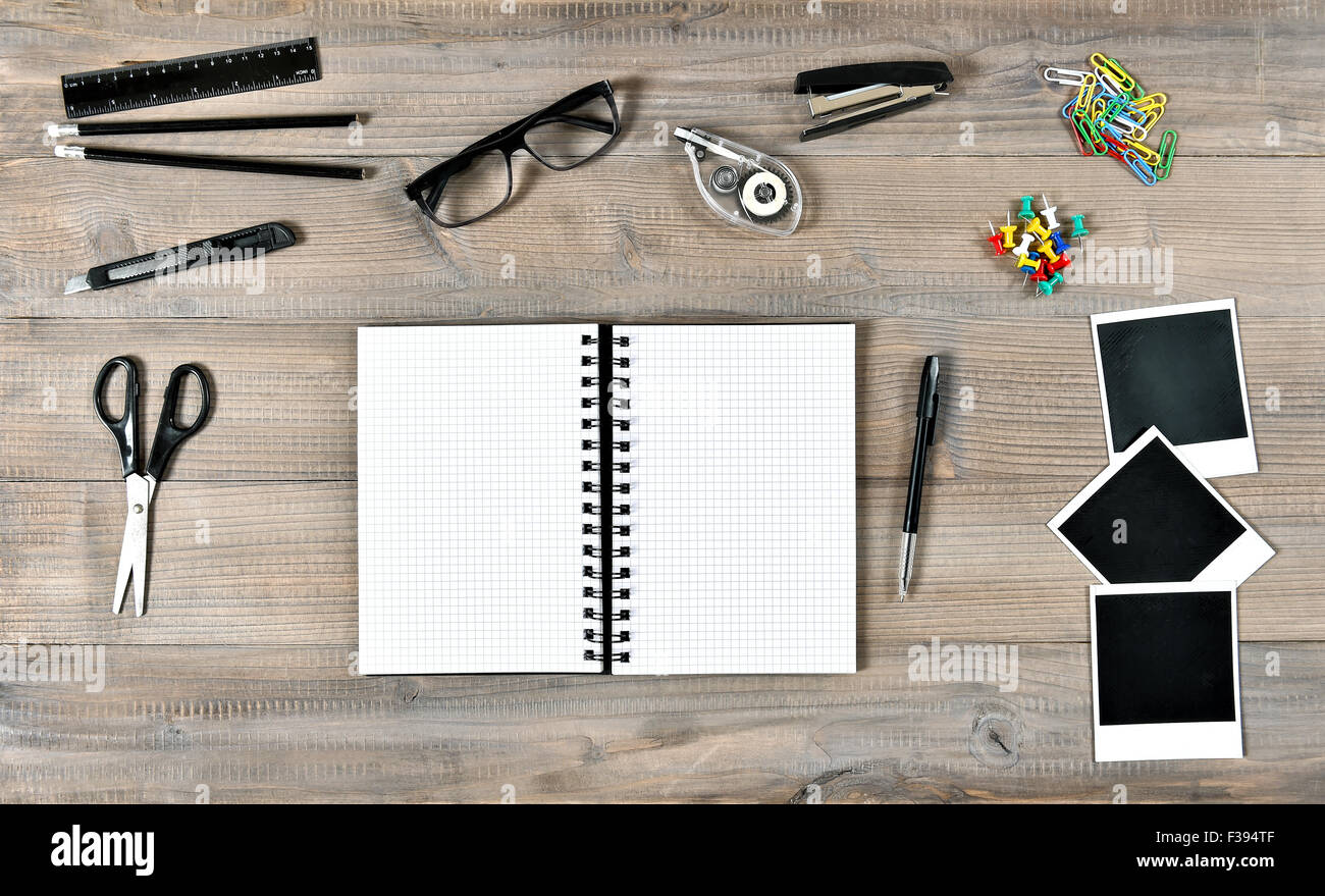 Office and school supplies over wooden desk background. Open book ...