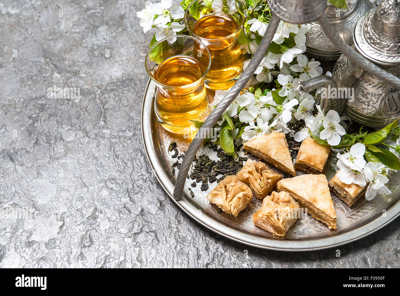 Tea glasses and pot, traditional sweets. Islamic holidays decoration ...