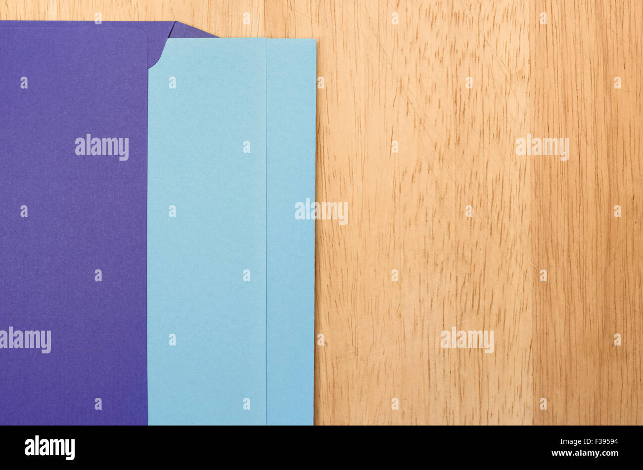 dark blue envelope and blue writing paper on a natural wood surface ...