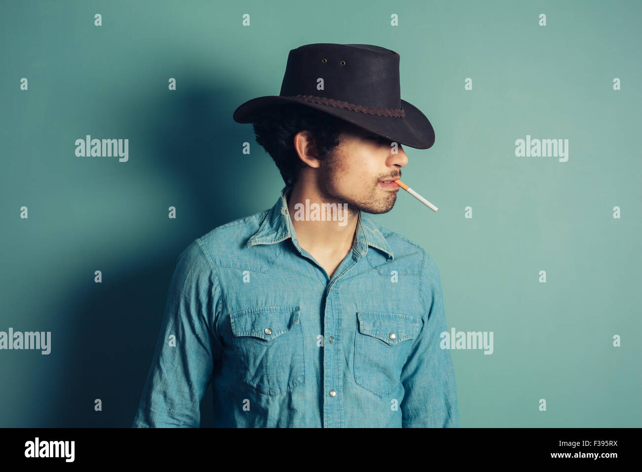 Asian young man smoking cigarette hi-res stock photography and images ...