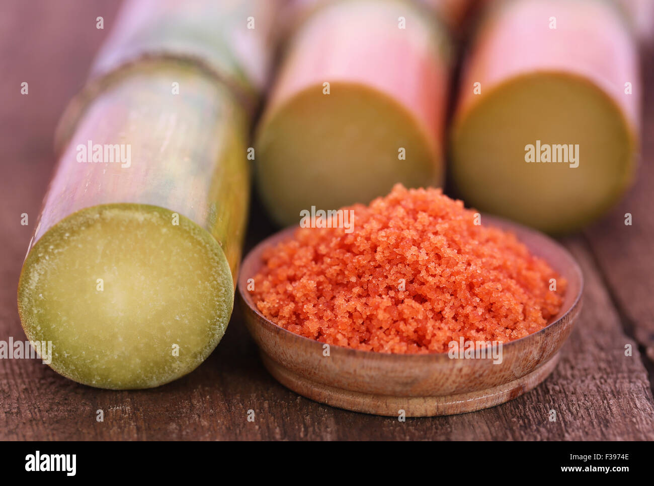 Piece of sugarcane with red sugar on a bowl Stock Photo - Alamy