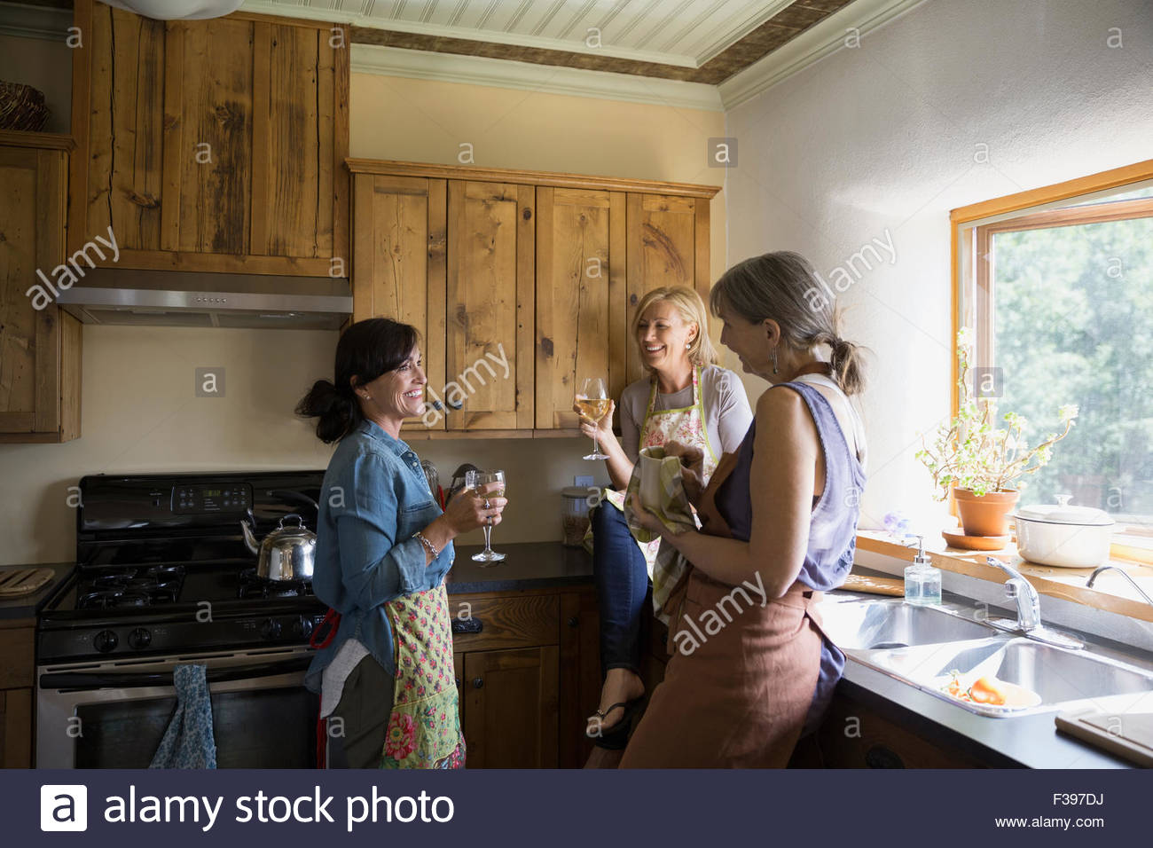 Woman drinking white wine her kitchen hi-res stock photography and ...