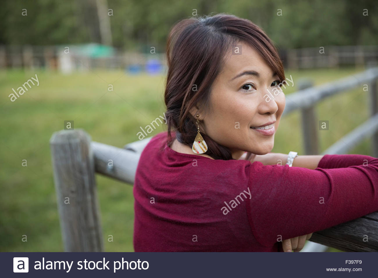 Woman looking over fence hi-res stock photography and images - Alamy